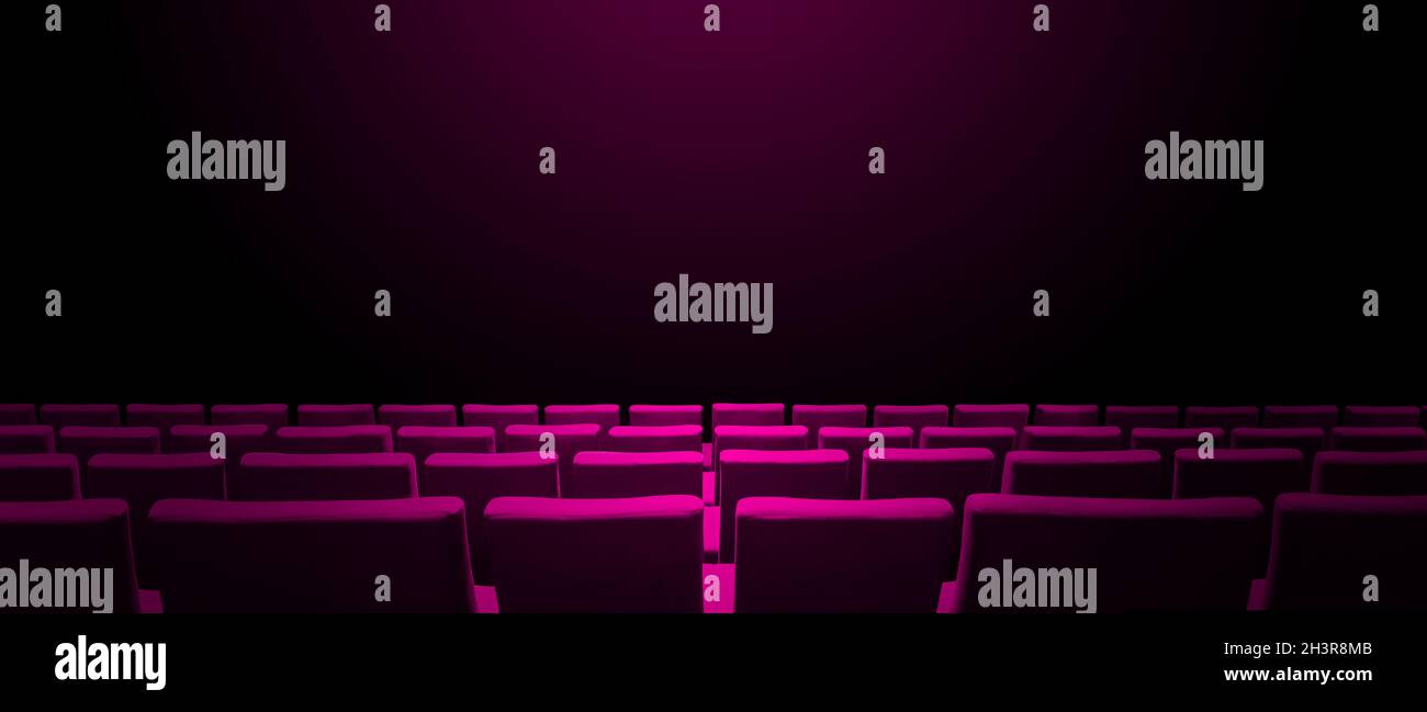 Cinema movie theatre with pink seats rows and a black background ...