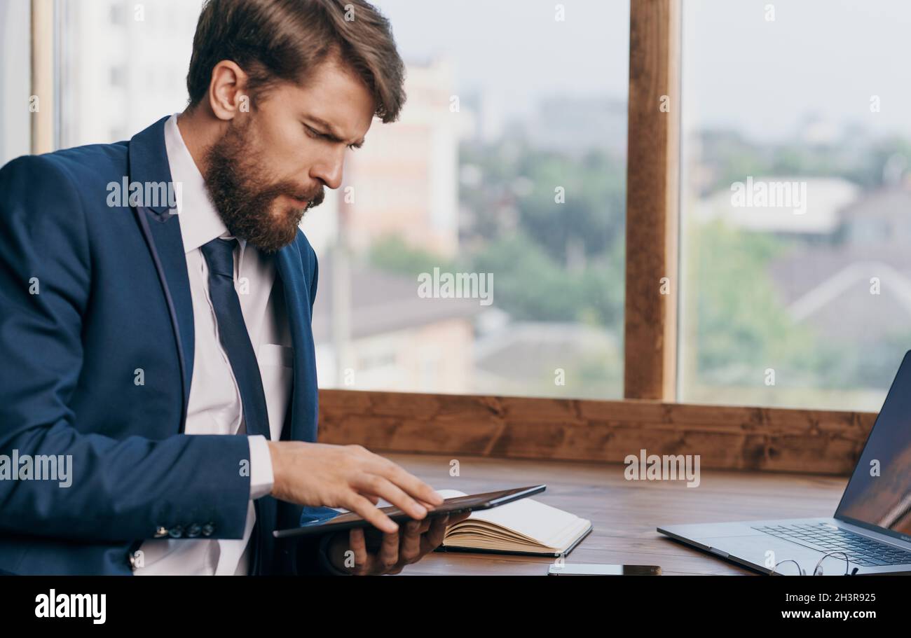 businessmen near the window with a laptop self-confidence Stock Photo ... businessmen near the window with a laptop self-confidence Stock Photo ...