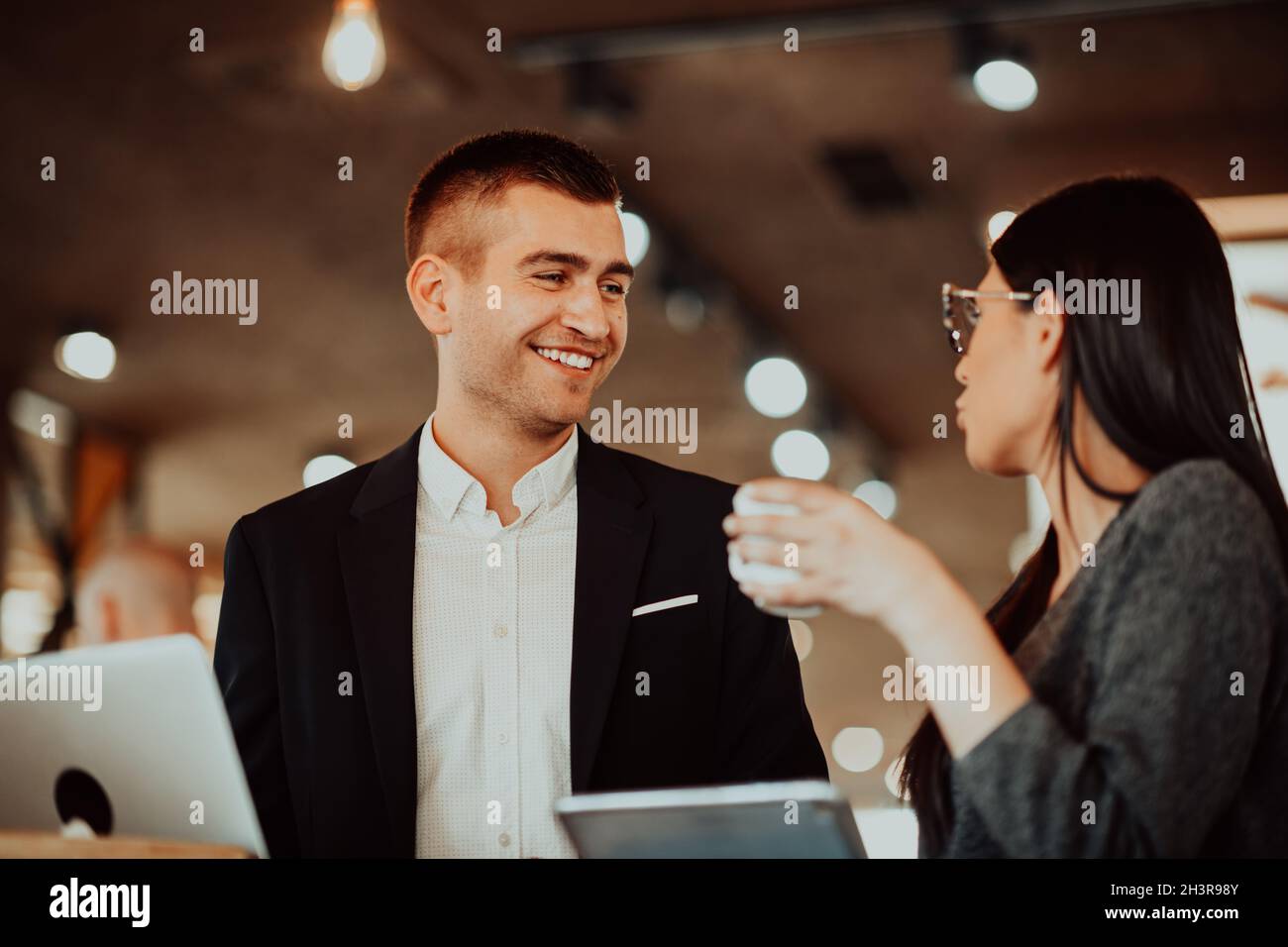 Modern man and woman use modern devices, laptop, tablet and smartphone ...