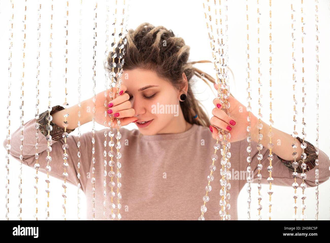 Happy woman shaking dreadlocks and smiling Stock Photo - Alamy