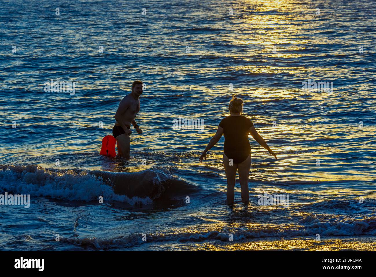 Going in for a dip off Clevedon beach Stock Photo - Alamy