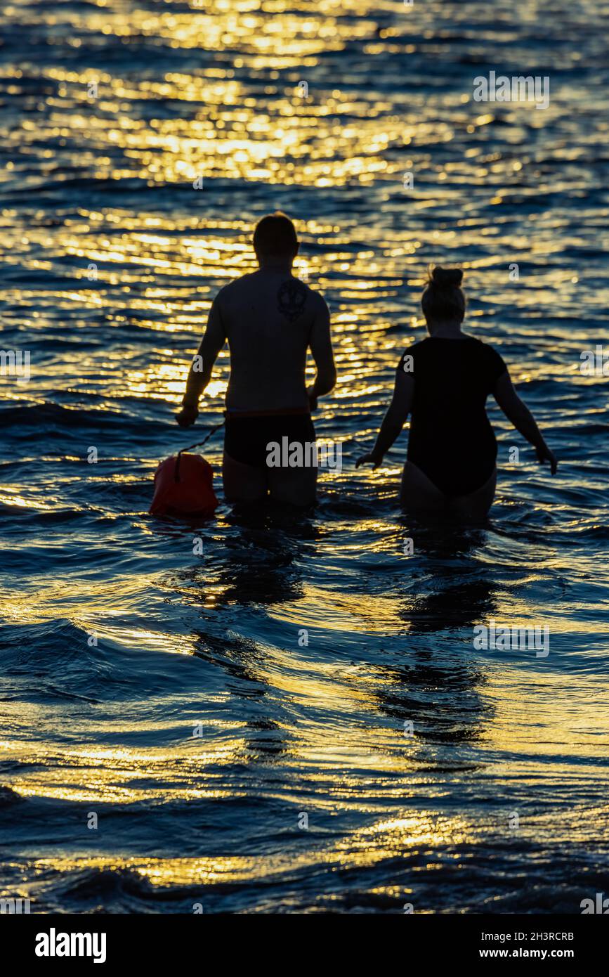 Going in for a dip off Clevedon beach Stock Photo - Alamy