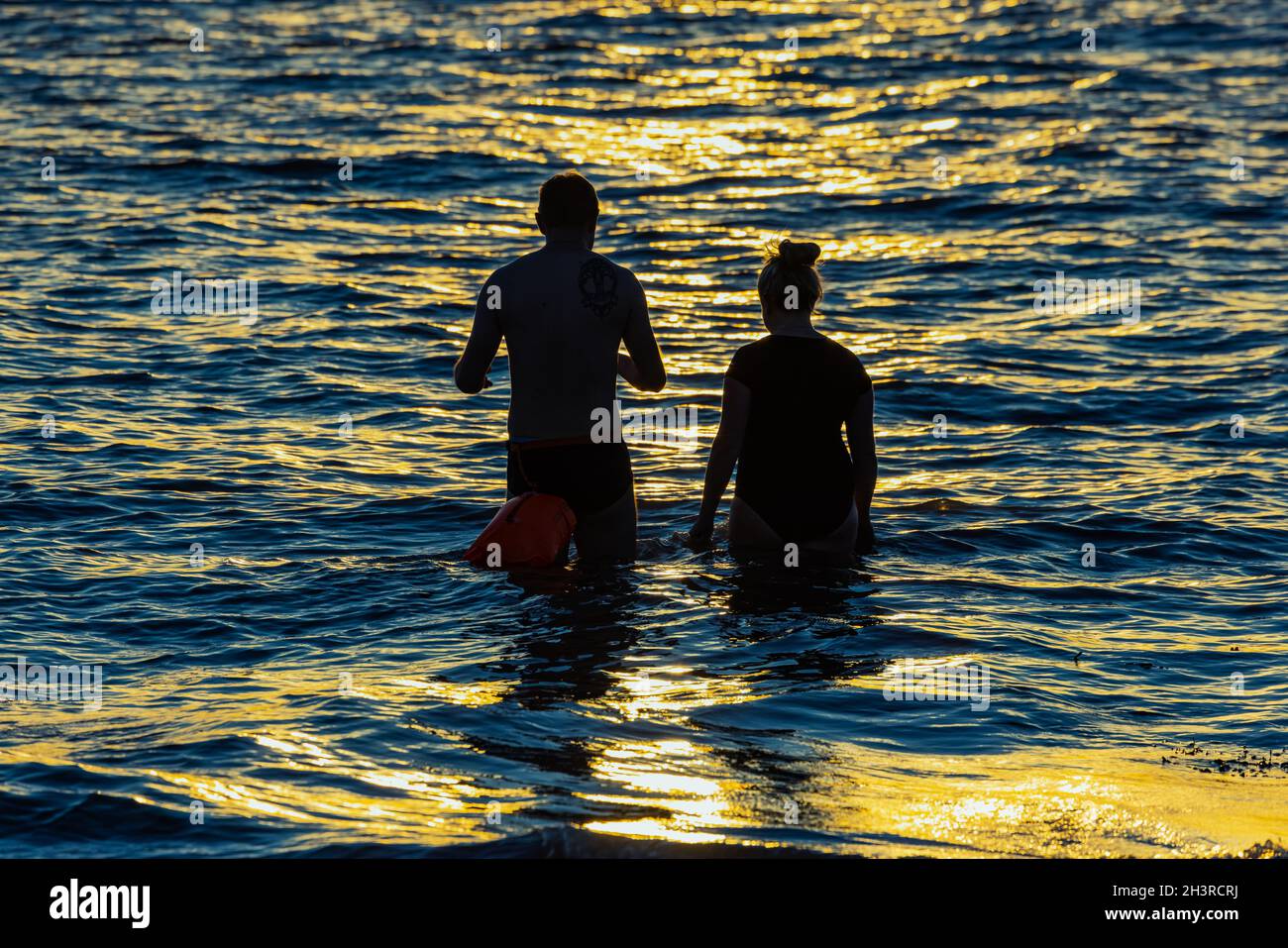 Going in for a dip off Clevedon beach Stock Photo - Alamy