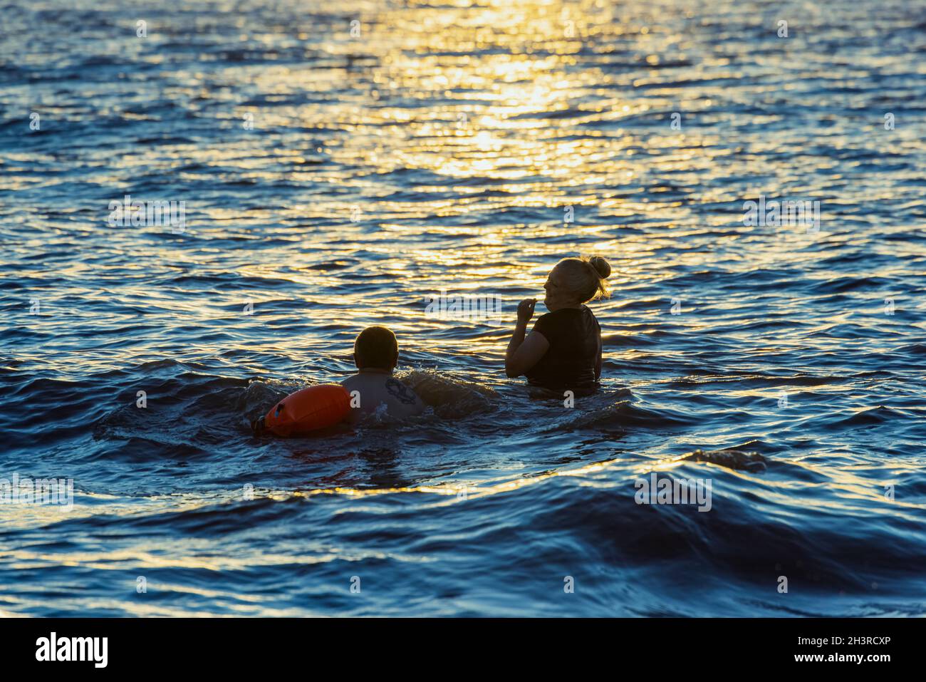 Going in for a dip off Clevedon beach Stock Photo - Alamy