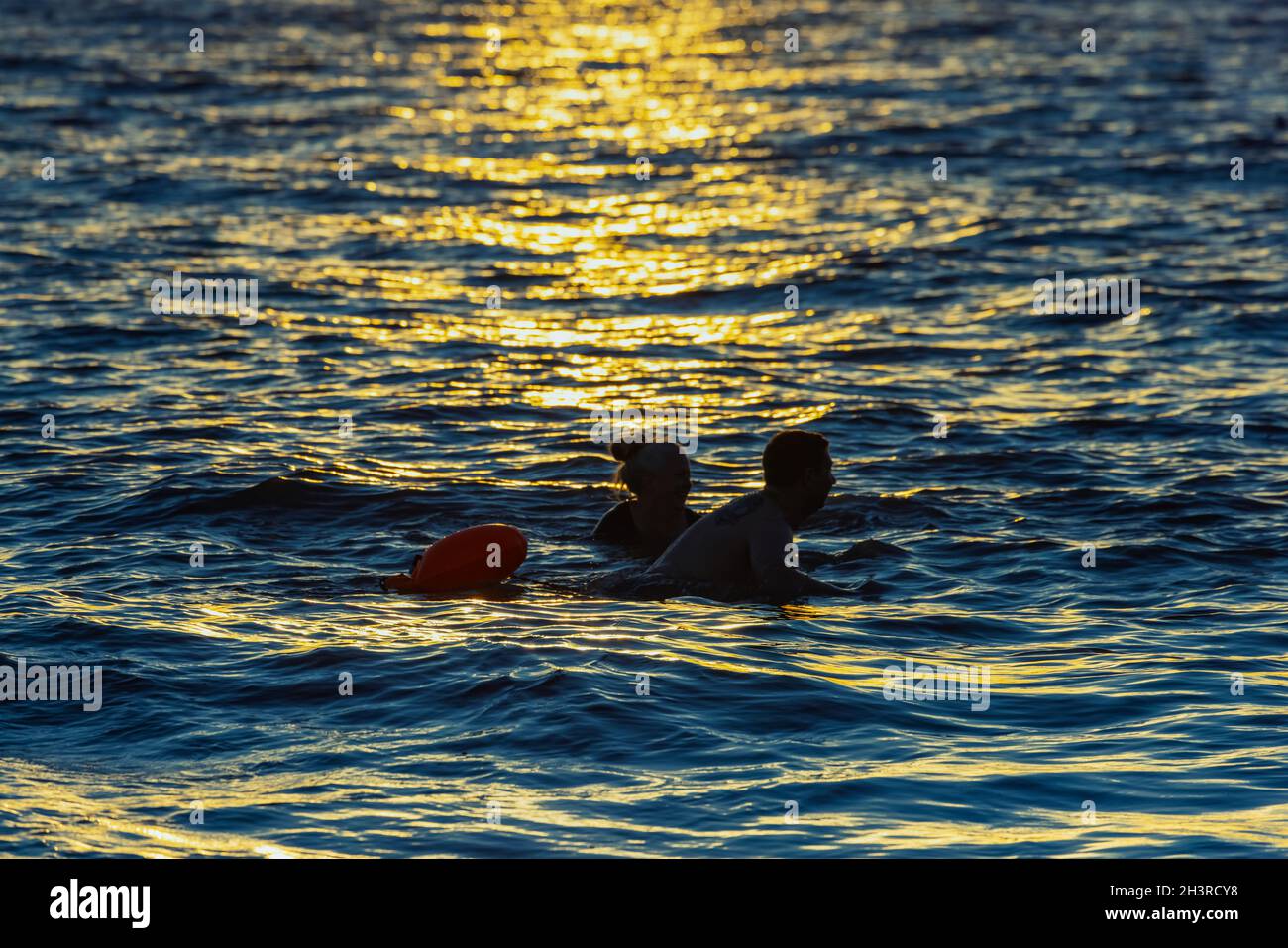 Going in for a dip off Clevedon beach Stock Photo - Alamy