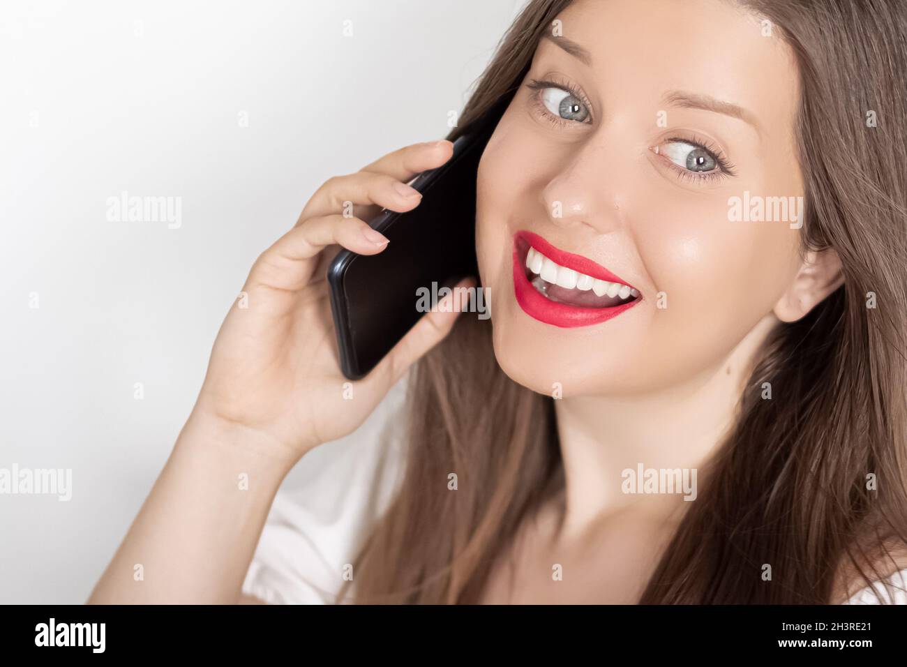 Happy smiling woman calling on smartphone, portrait on white background ...