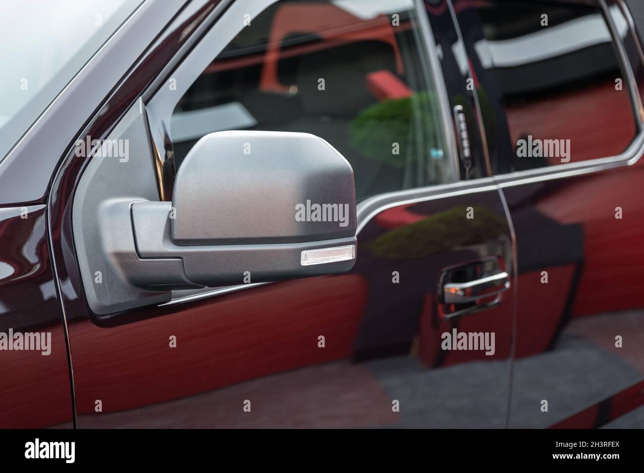 Close-up of the side left mirror and window of the car body black SUV ...