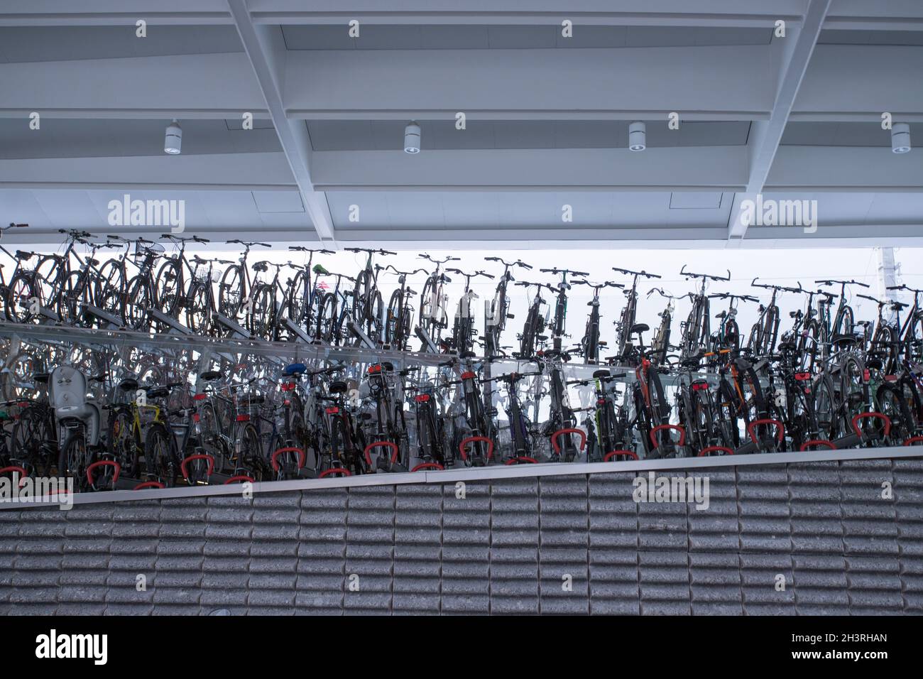 Bike rack on a train station: Stacked bikes Stock Photo - Alamy