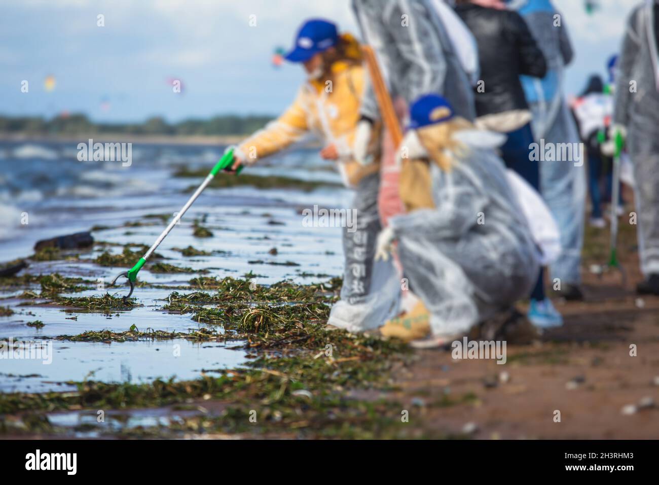 Process of cleaning up the shore beach line from litter garbage rubbish ...