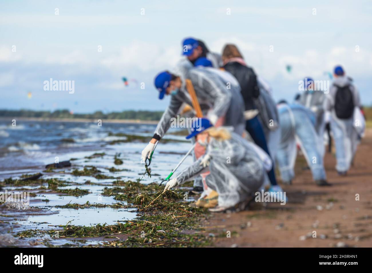 Process of cleaning up the shore beach line from litter garbage rubbish ...