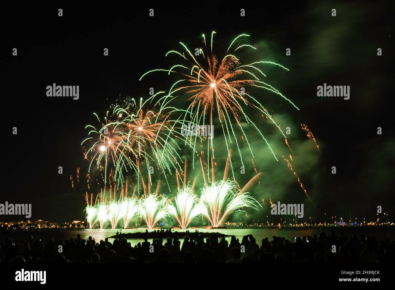 Scenic fireworks glowing in the night for the 14th of July celebrations ...