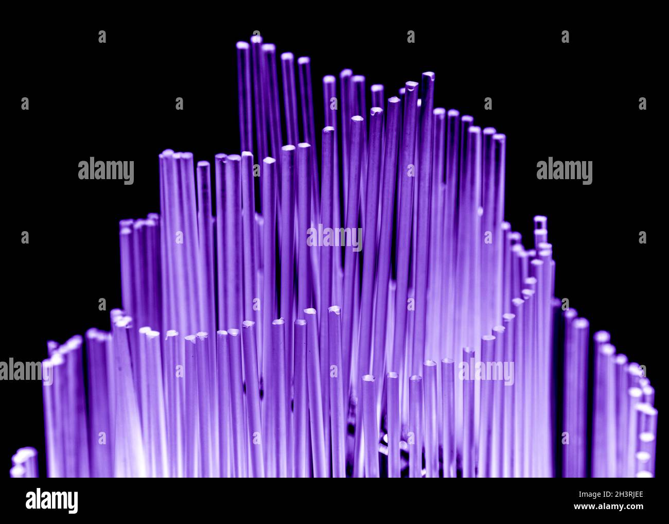 Glowing glass rods in purple on a black background Stock Photo - Alamy