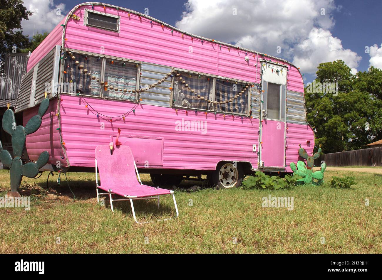Pink Travel Trailer with Chair and cactus plus blue sky and clouds ...