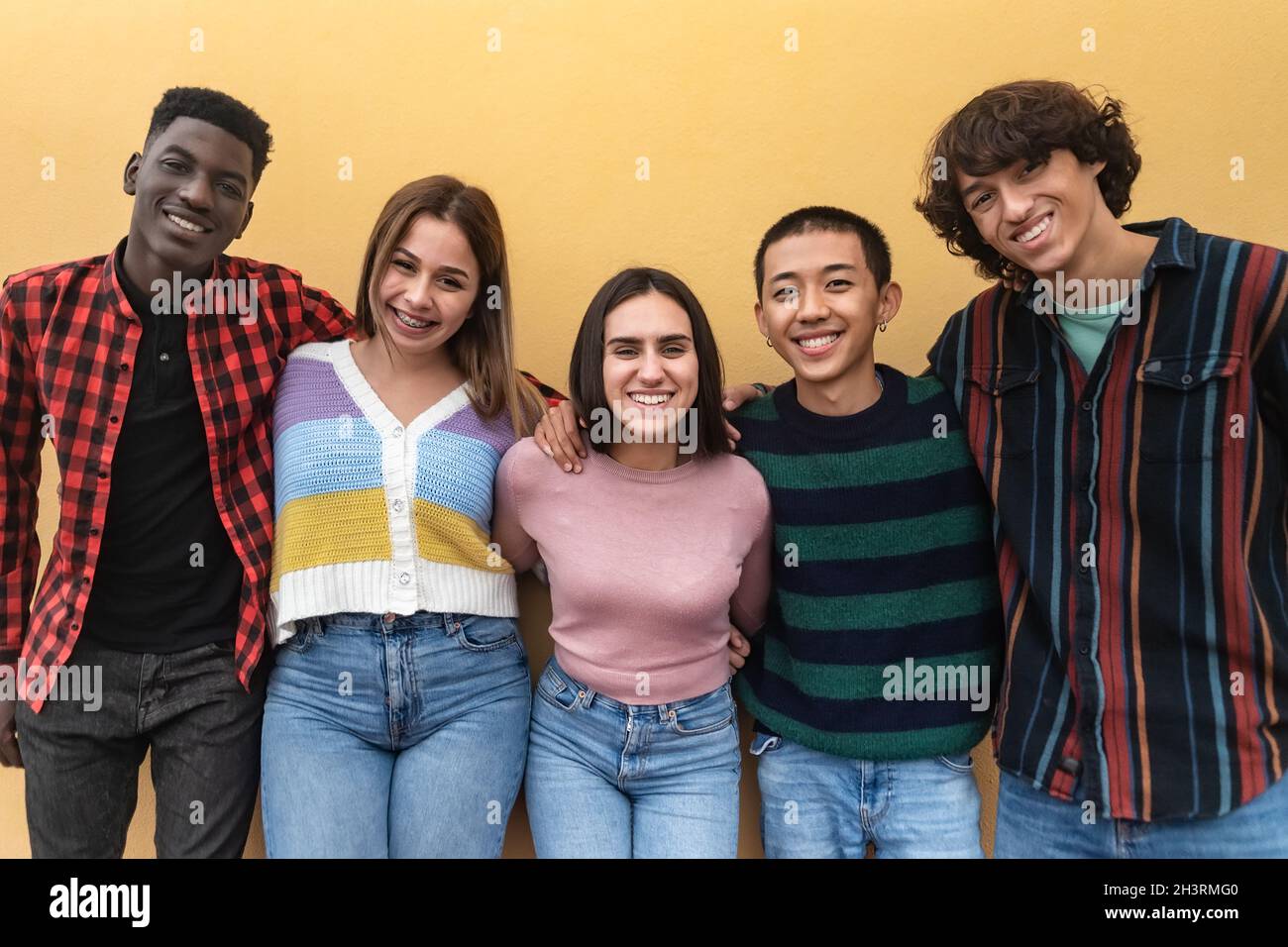 Happy multiracial group of teenagers having fun outside school - Young ...