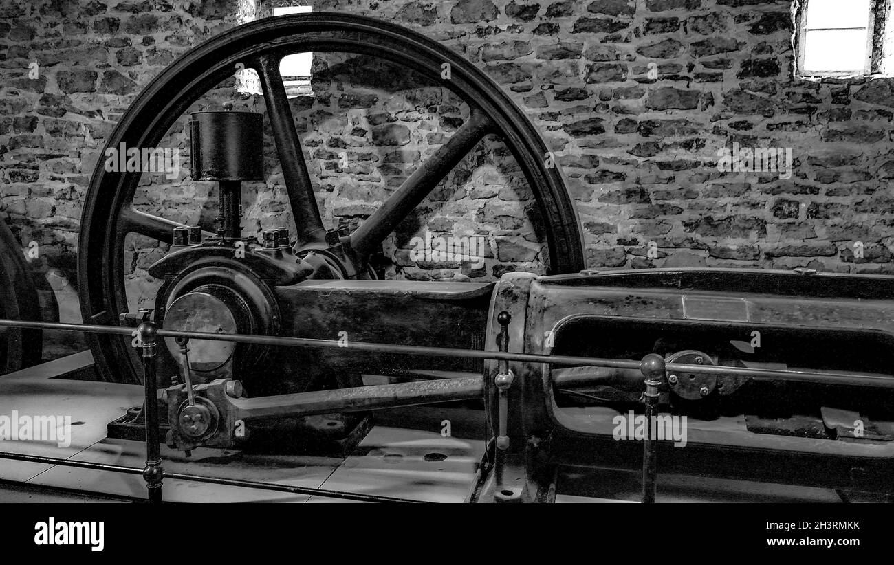 Grayscale shot of an old aged metal wheel machine Stock Photo - Alamy