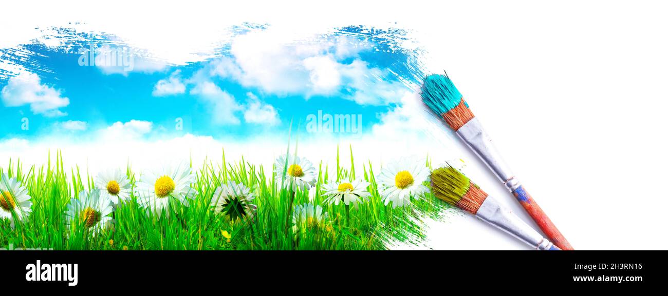 Painting the spring landscape. Brush with blue paint over sky and green ...
