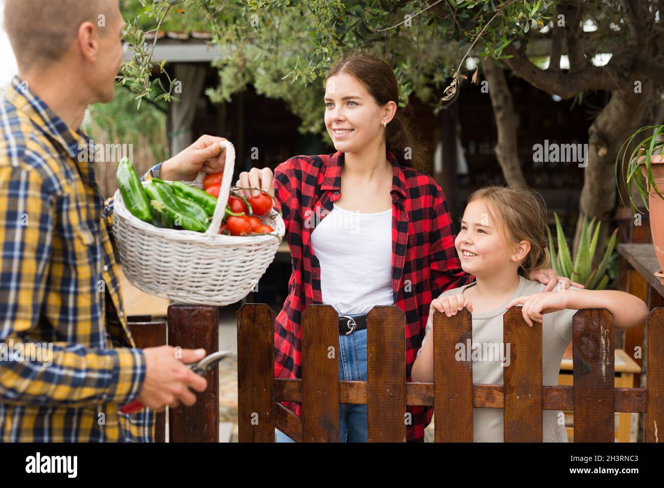 Family talking about rich harvest at backyard Stock Photo - Alamy