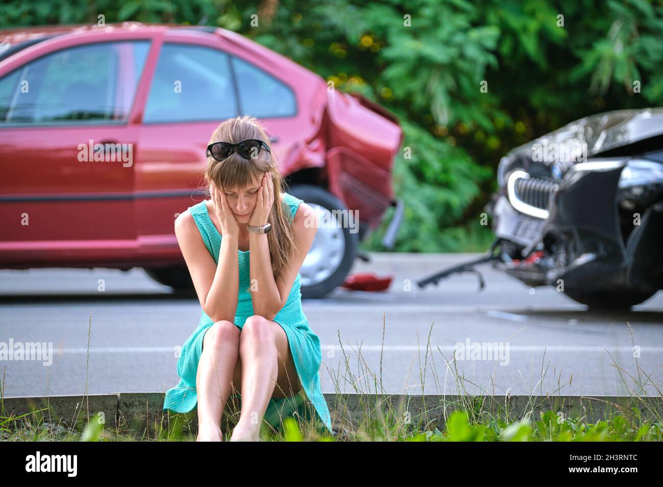 Stressed woman driver sitting on street side shocked after car accident ...
