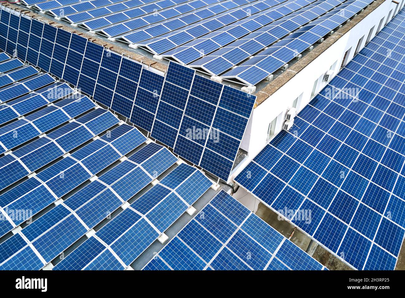 Aerial view of solar power plant with blue photovoltaic panels mounted ...