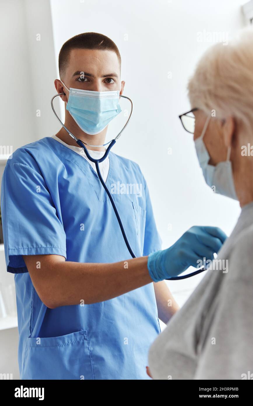 Medical worker examine sick mature hi-res stock photography and images ...