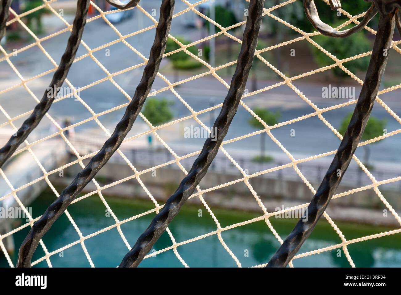 Close-up of iron railings and strong mesh netting protecting children ...