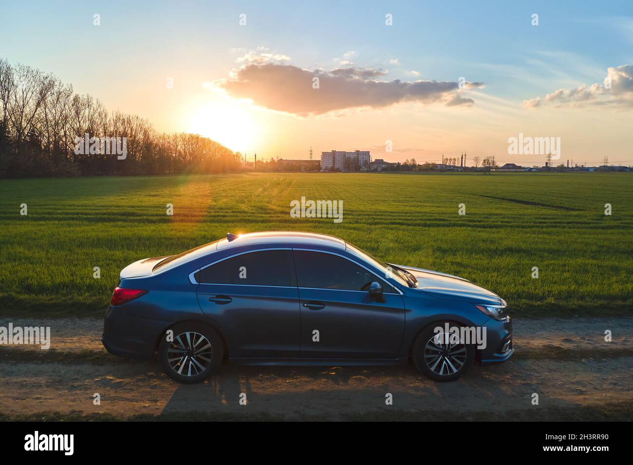 Aerial view of sedan car driving fast on dirt road at sunset. Traveling ...