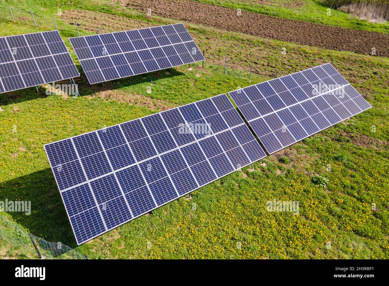 Aerial view of blue photovoltaic solar panels mounted on backyard ...