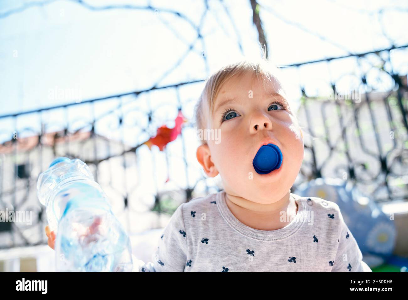 Small child stuffed a plastic bottle cap into his mouth, which he is ...