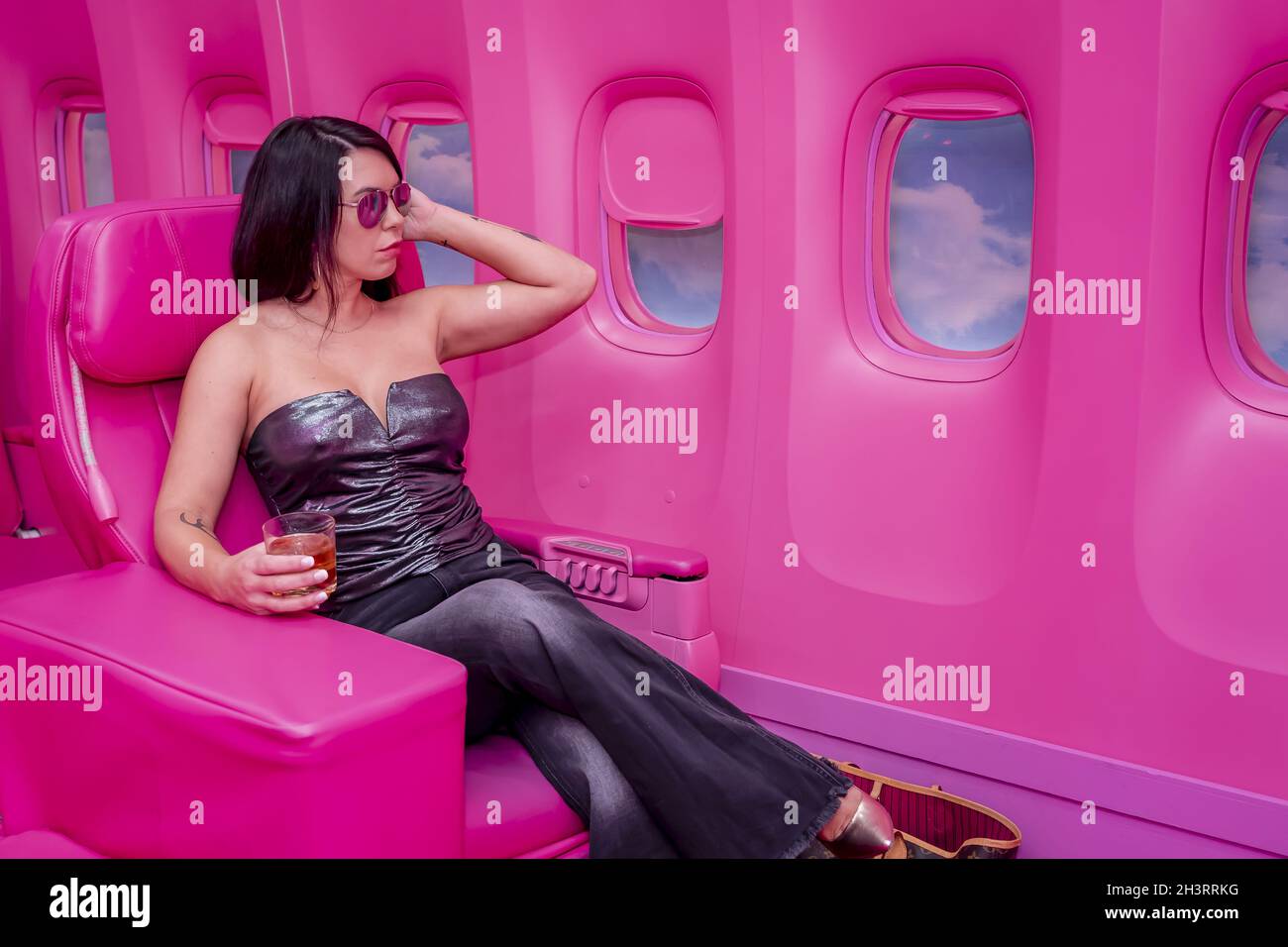 A Lovely Brunette Model Poses For The Camera While Having Fun On A Pink ...