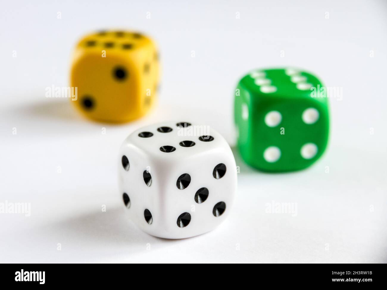 Three colorful dices isolated on white background Stock Photo - Alamy