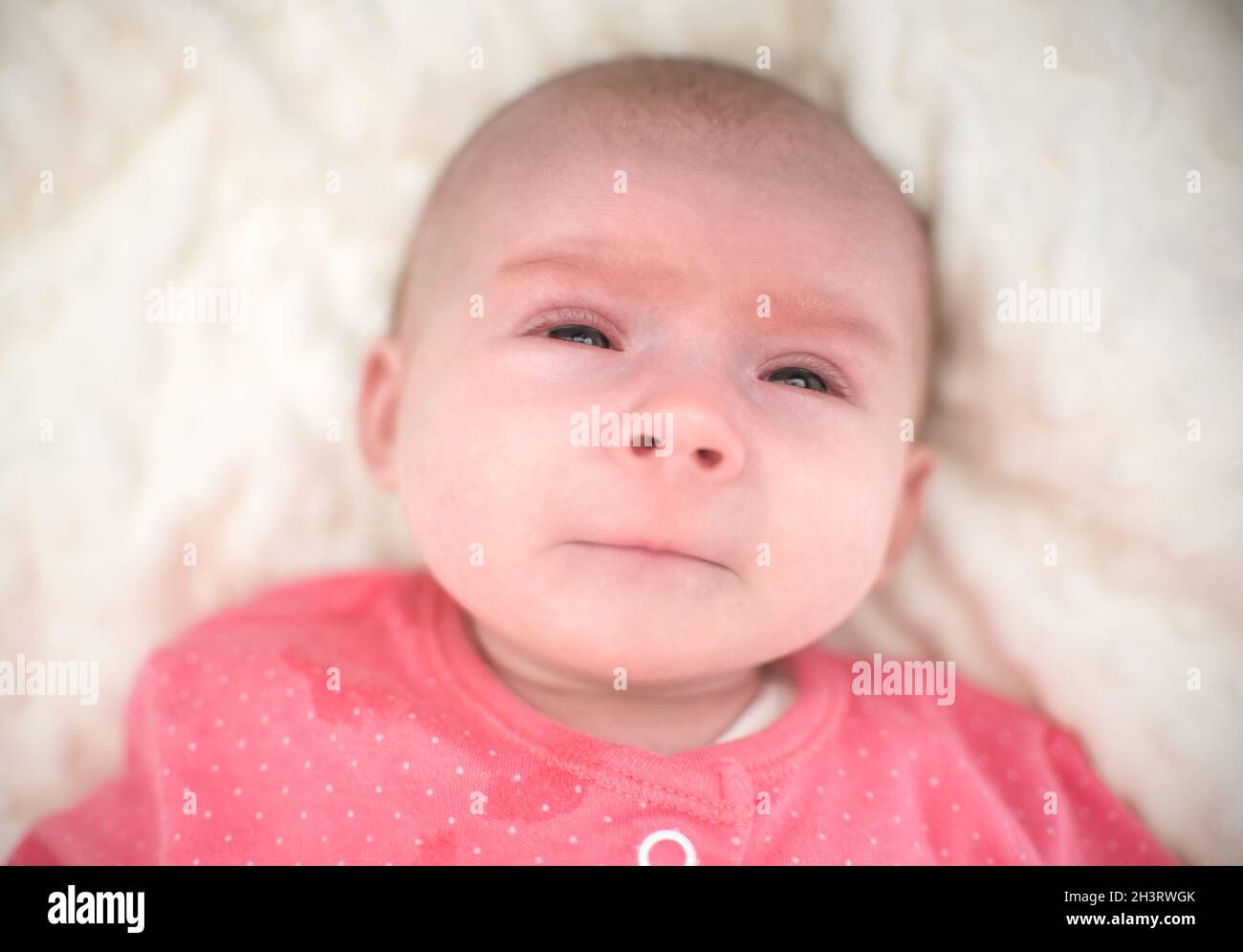 Newborn with very sad face start to cry Stock Photo - Alamy