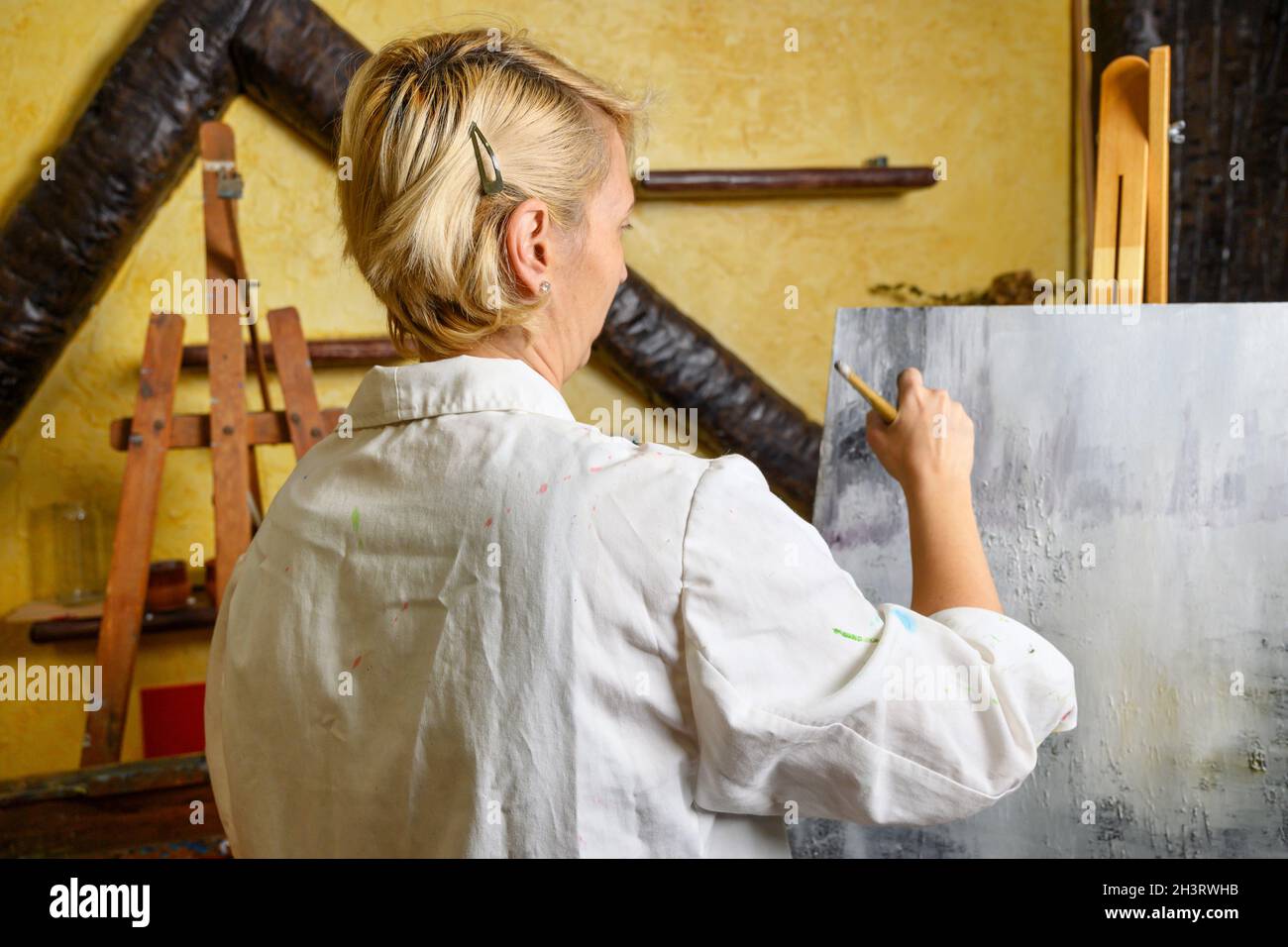 Woman having fun painting in art class Stock Photo - Alamy