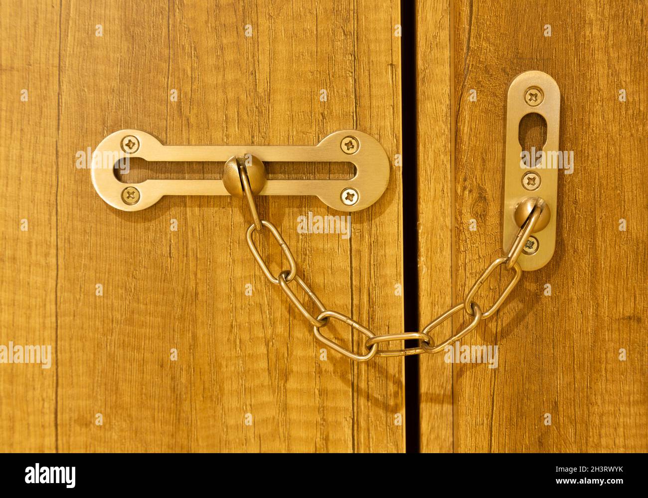 Additional security lock with chain and sliding on wooden door Stock ...
