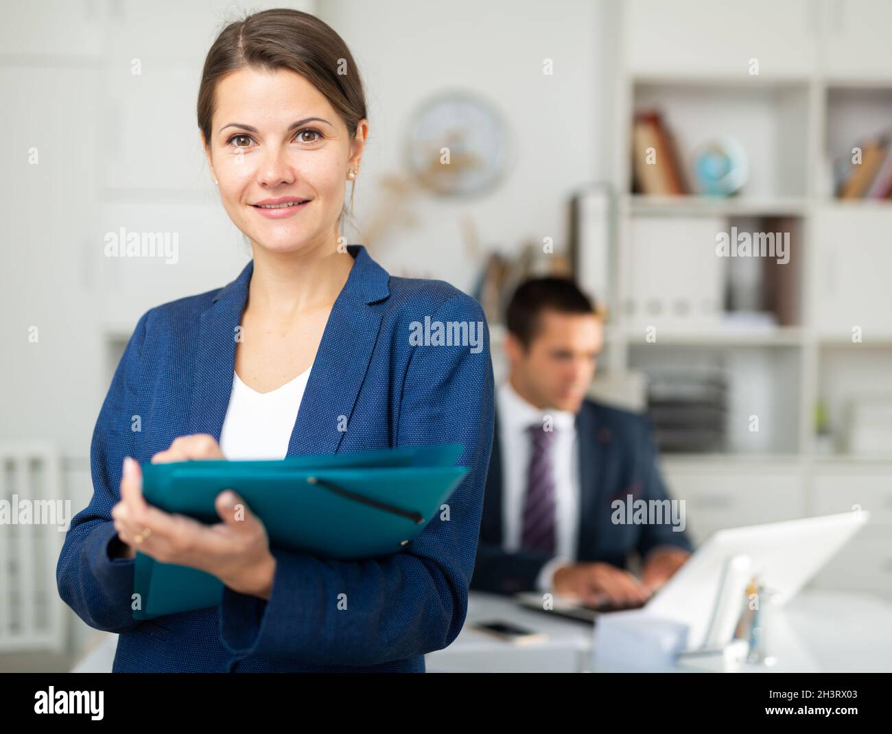 Female office worker is standing with documents before signing Stock ...