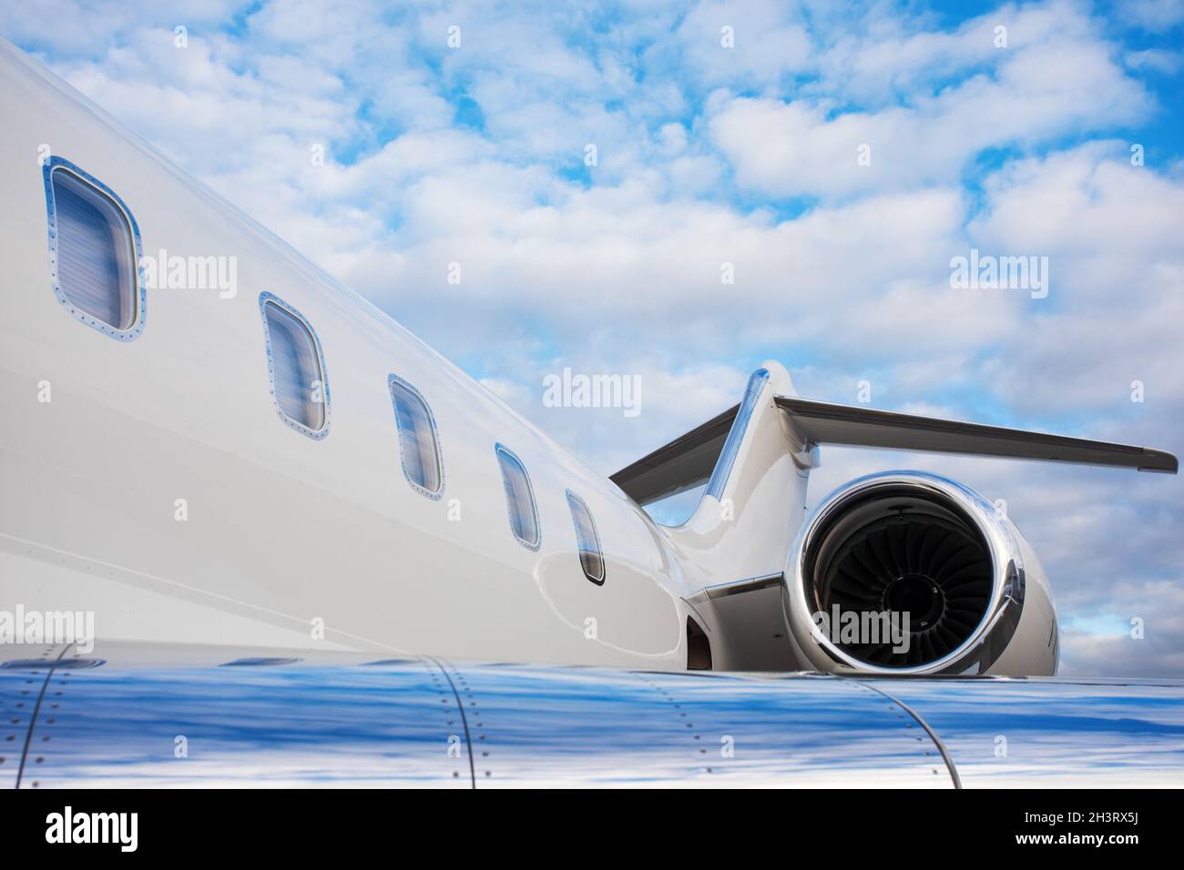 part of modern private business jet airplane with a tail and wing over ...