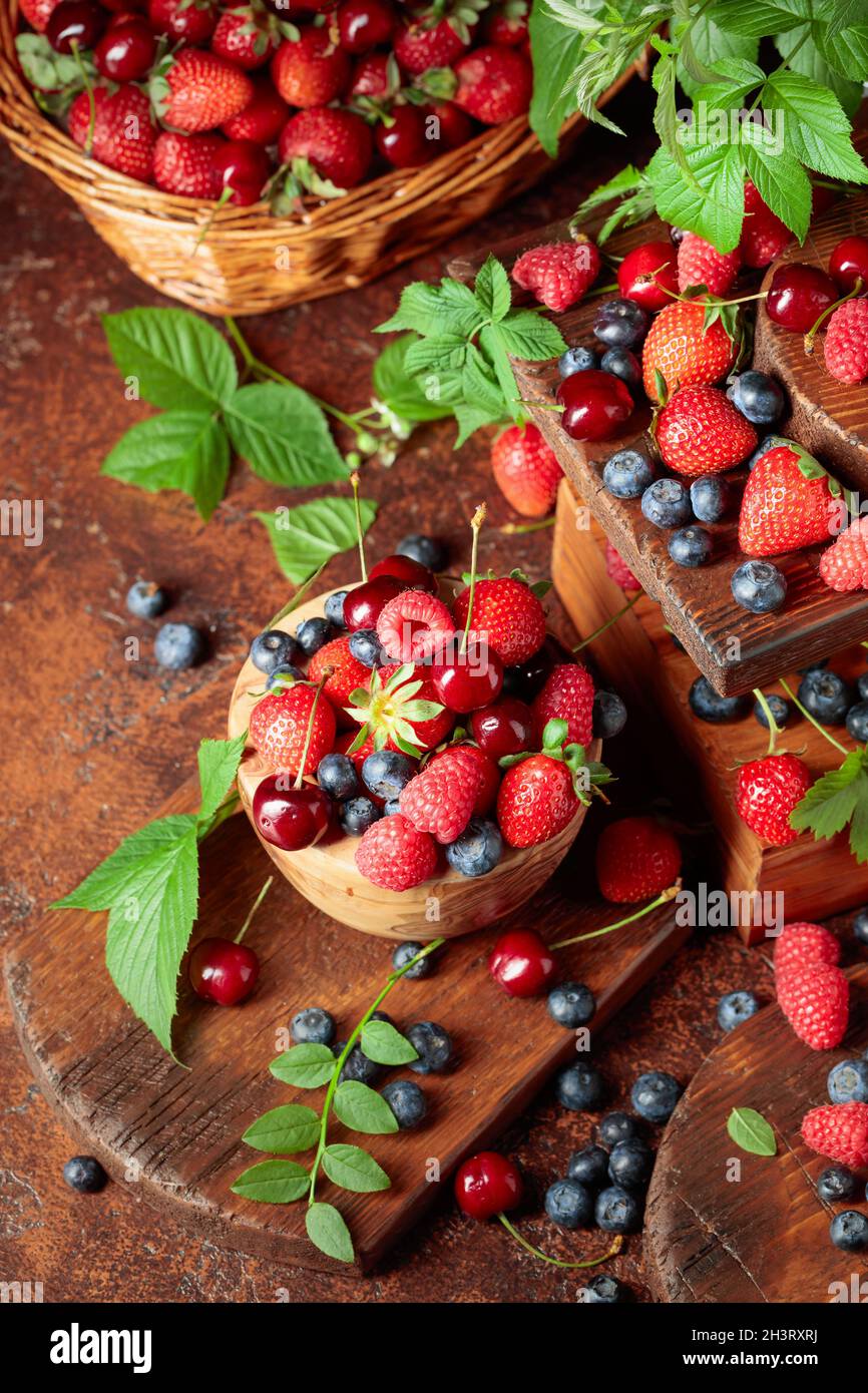 Assorted fresh berries with leaves. Strawberries, raspberries ...