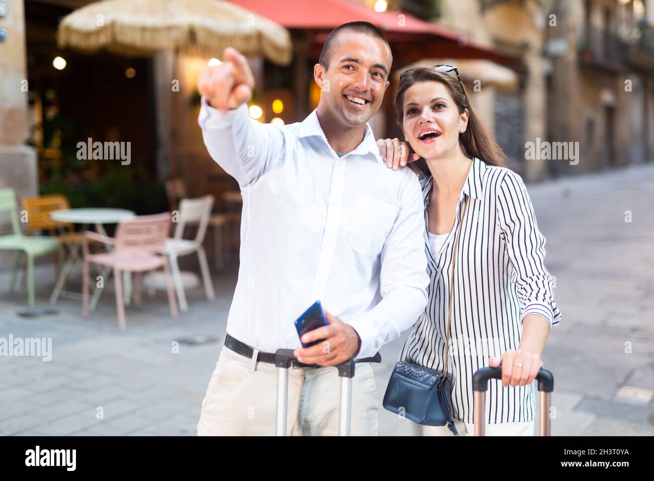 Smiling man and woman visiting city attractions on vacation Stock Photo ...