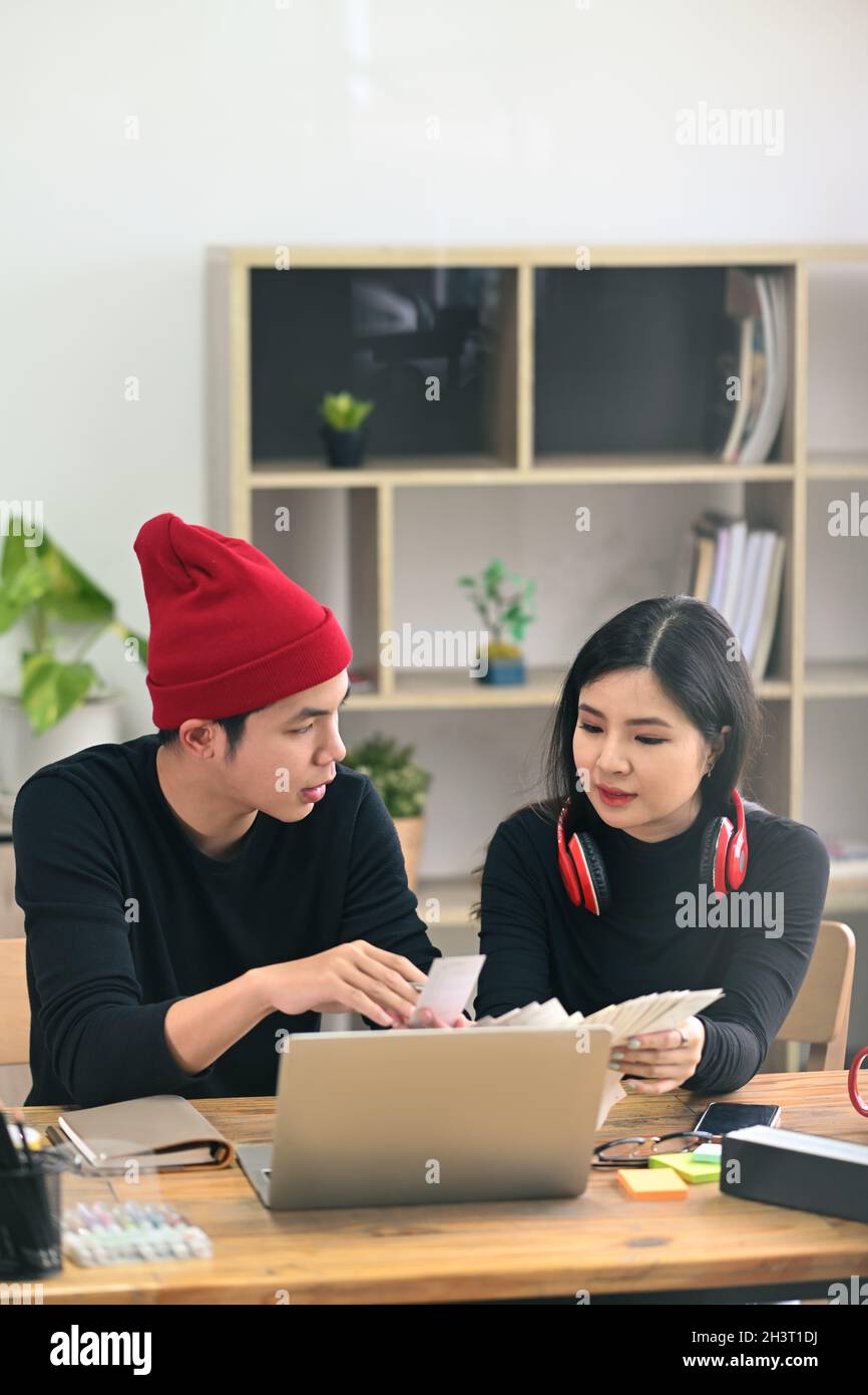 Two graphic designer colleagues working on project together Stock Photo ...