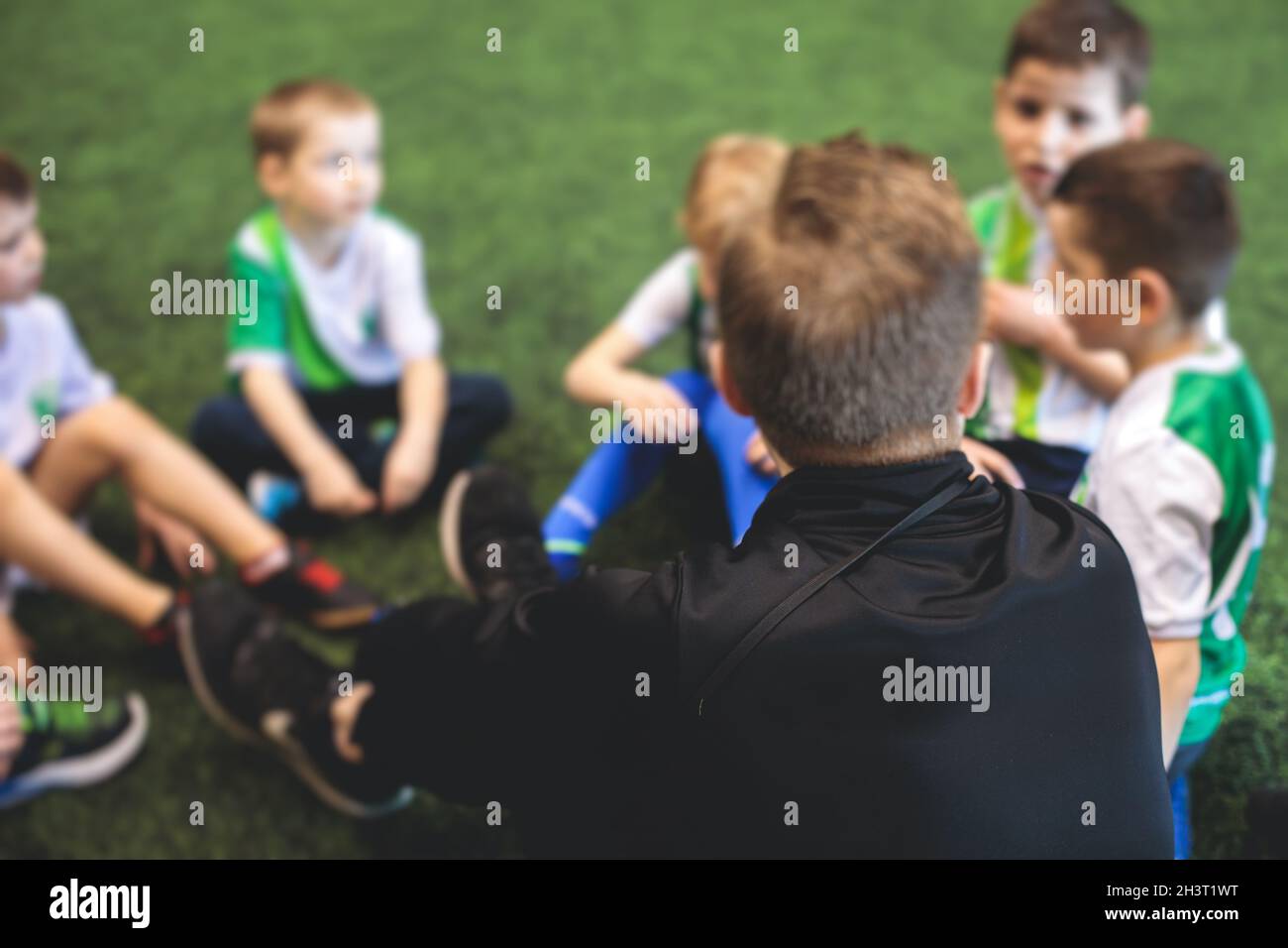 Junior young football team with a coach, group of kids children soccer ...