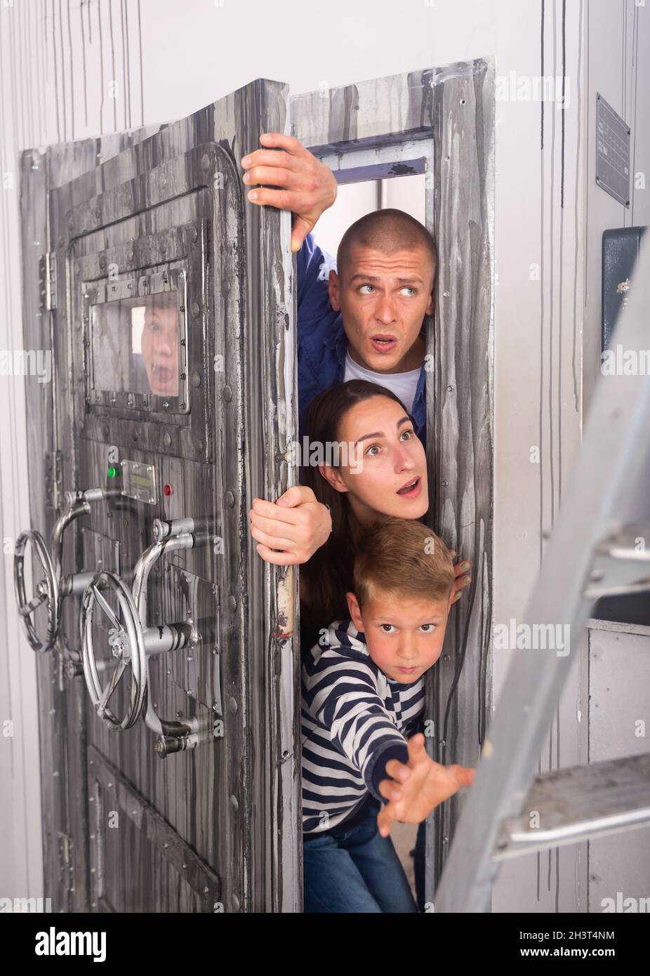 Scared family trying to get into room through bunker door Stock Photo ...