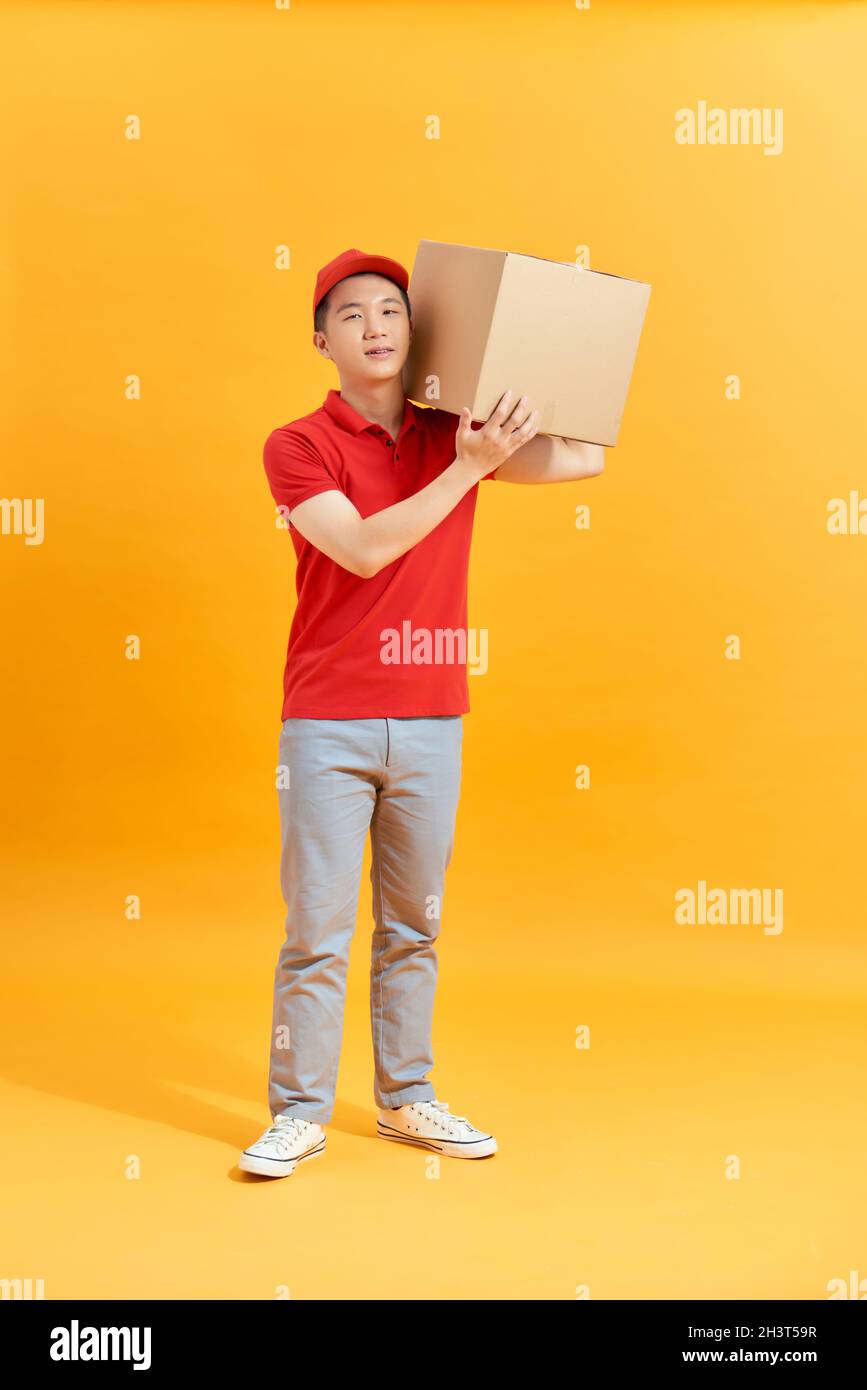 Delivery man holding parcel box isolated on white background Stock ...