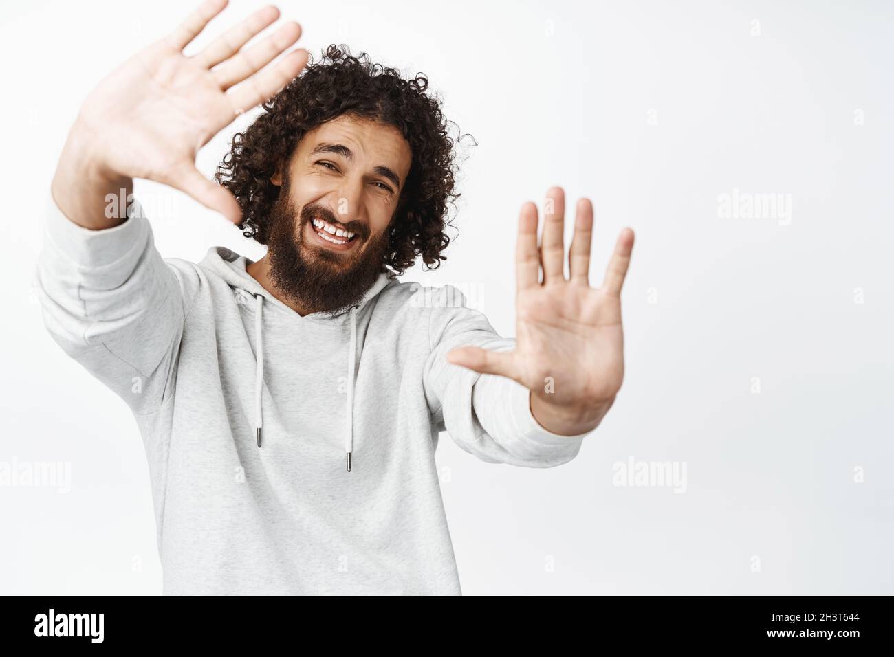 Portrait of carefree hispanic man picturing, extend hands dreamy and ...