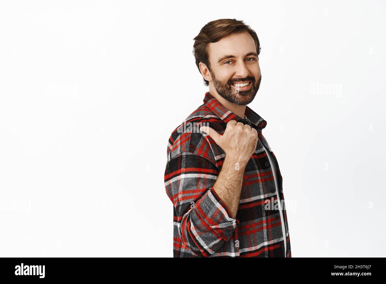 Portrait of smiling man pointing left and showing advertisement ...