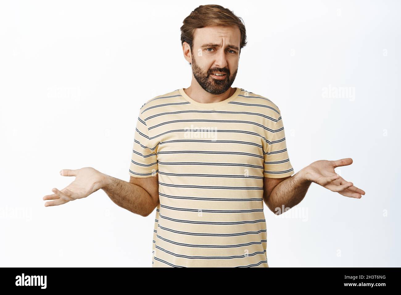 Whats wrong. Confused man shrugging shoulders and looking questioned ...