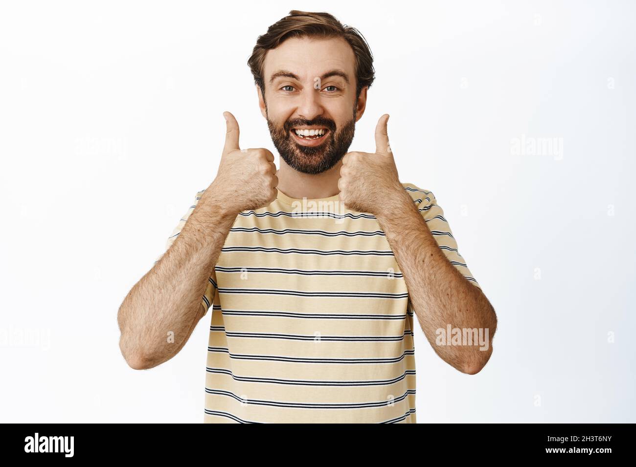 Happy smiling guy shows his support with thumbs up near face, likes and ...