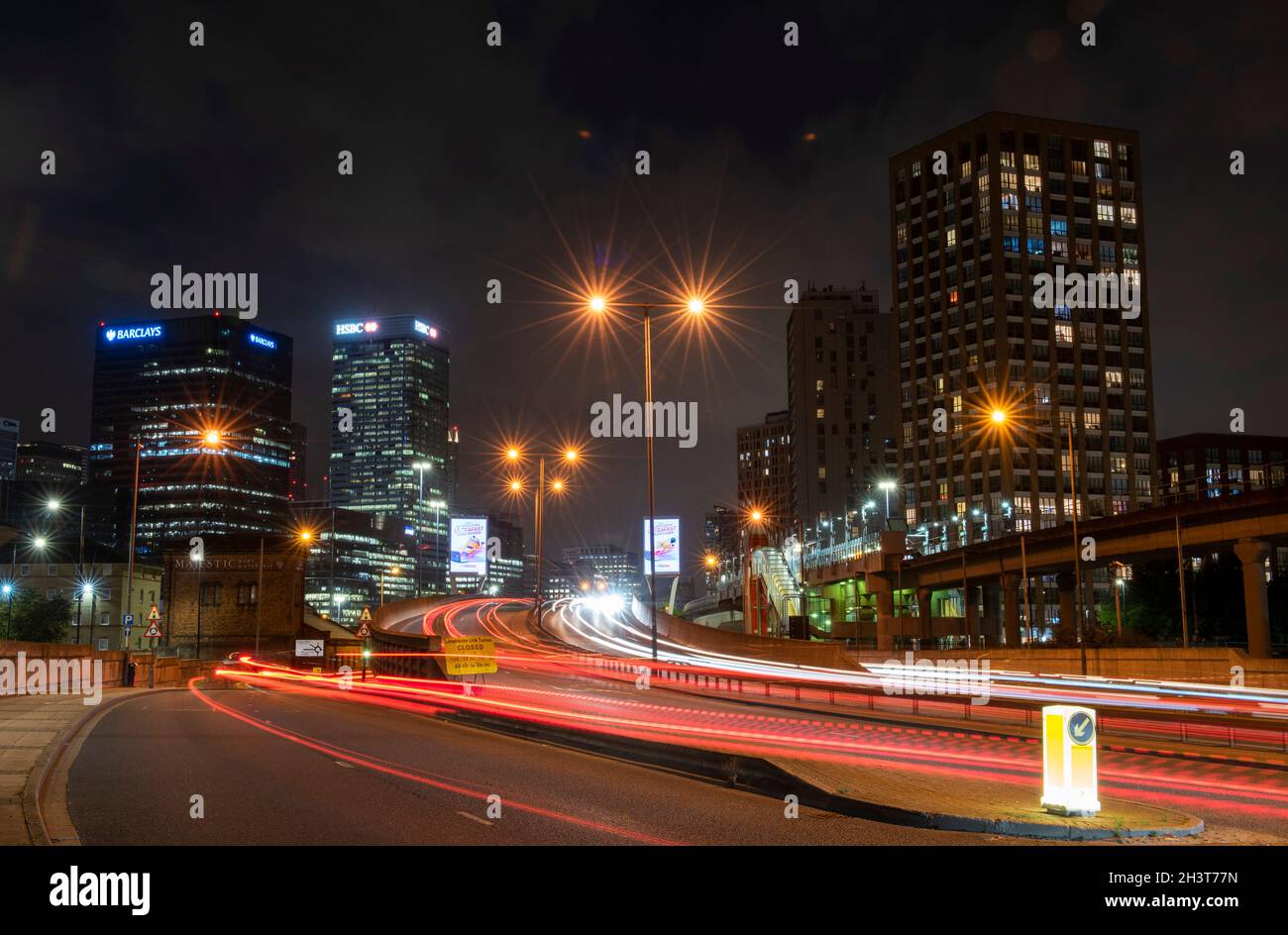 Traffic light trails on Aspen Way looking towards Canary Wharf, London ...