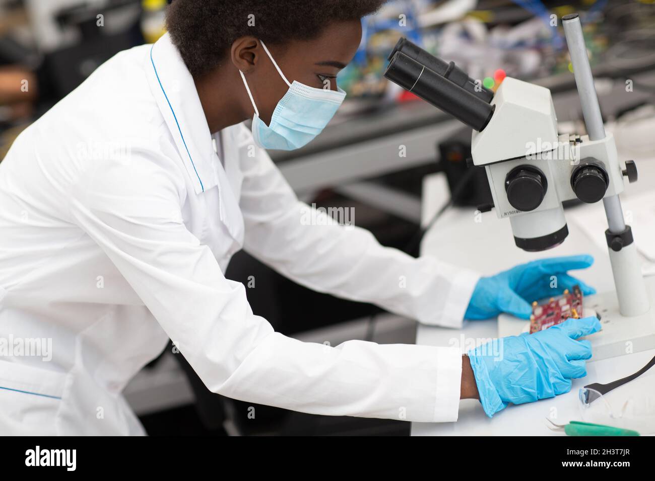 Scientist african american woman working in laboratory with electronic ...