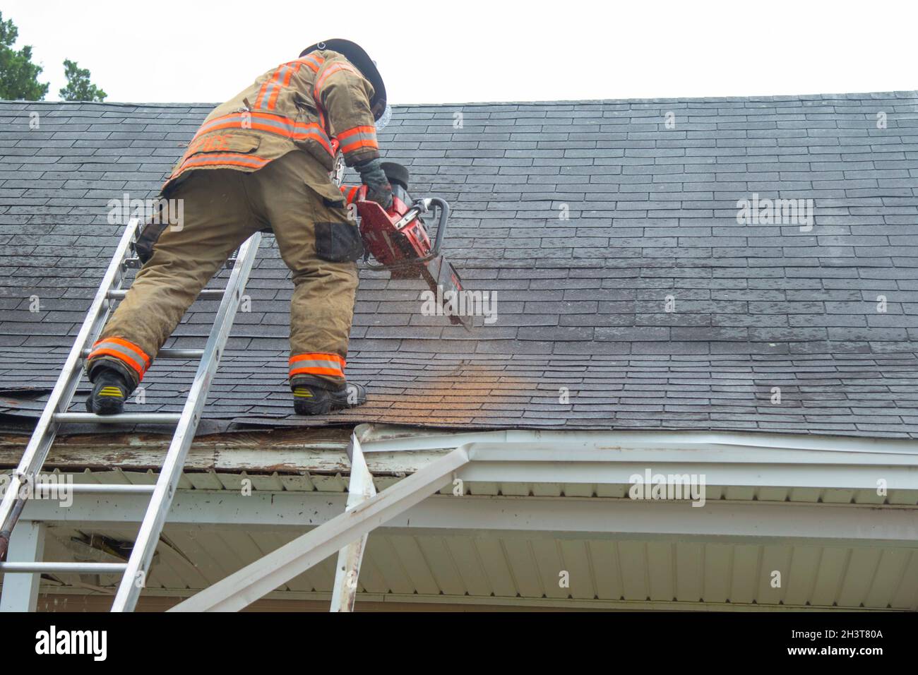 Fireman with chainsaw on roof hi-res stock photography and images - Alamy