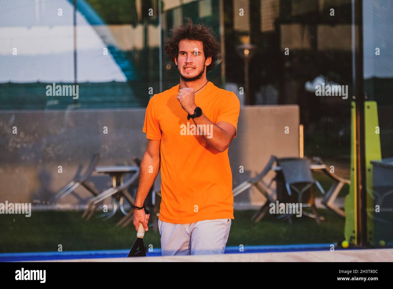 Padel player exulting after winning a match - Young athlete celebrating ...