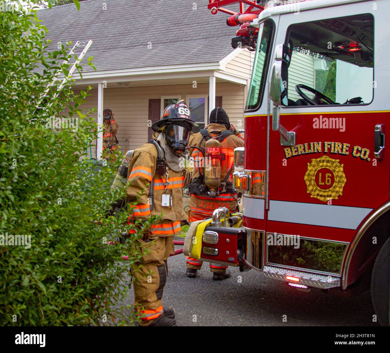 Firefighters don breathing apparatus preparatory to entering smoke ...